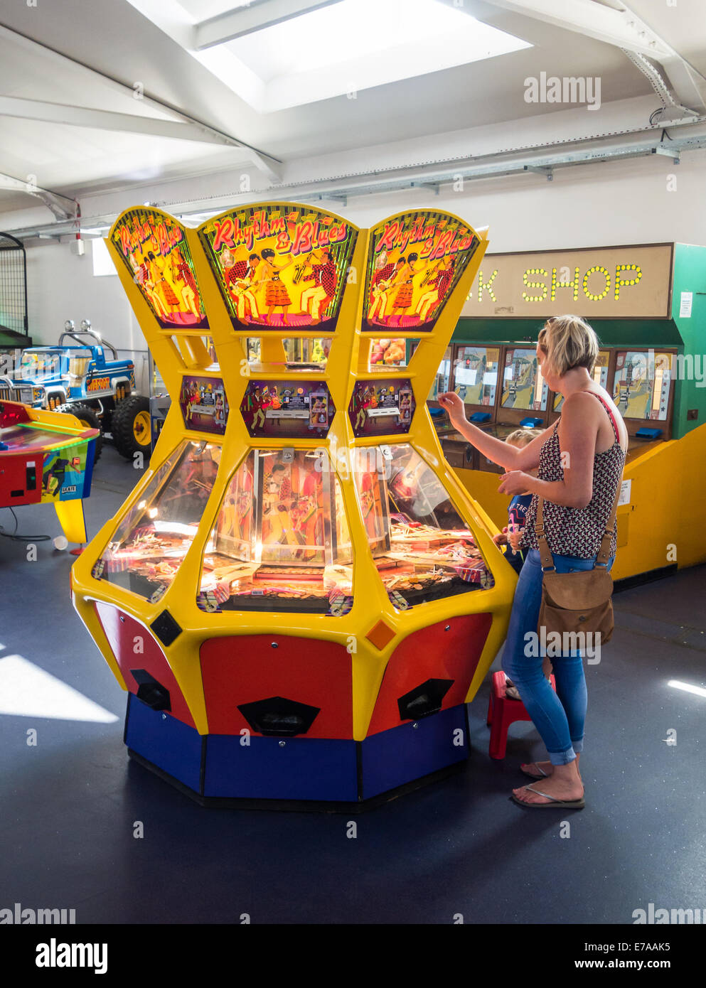 A woman and her child play on a slot machine called Rhythm & Blues on ...