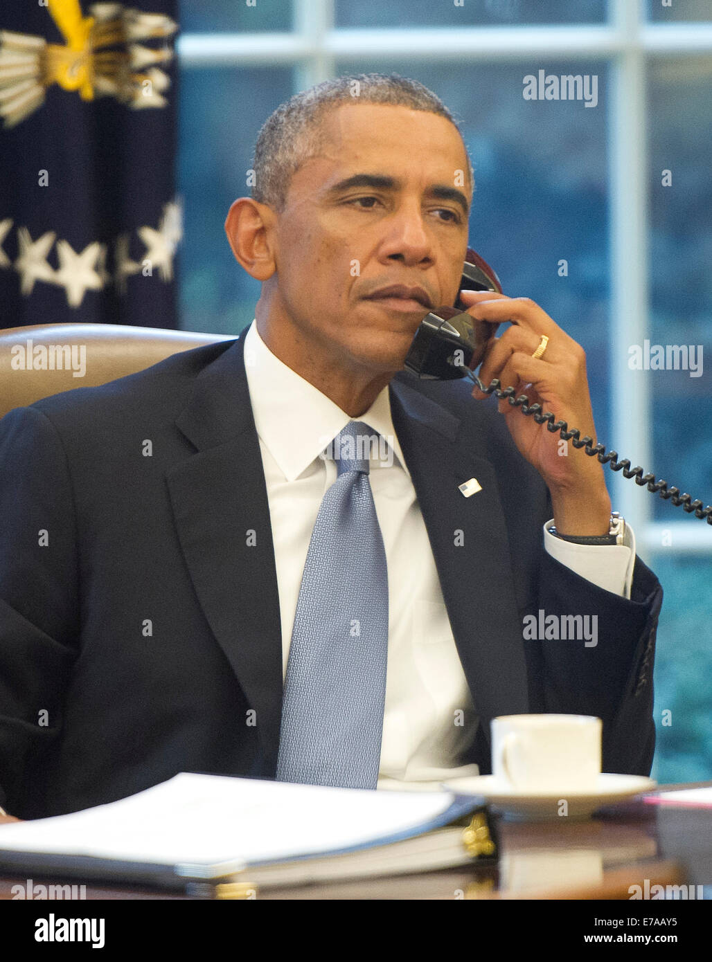 United States President Barack Obama is photographed through an Oval ...