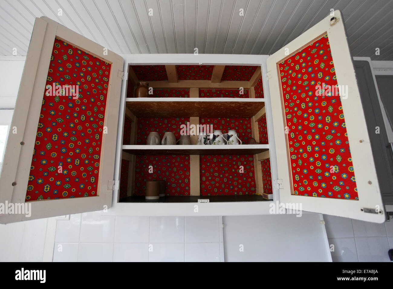 vintage kitchen cupboard with red fablon inside Stock Photo - Alamy