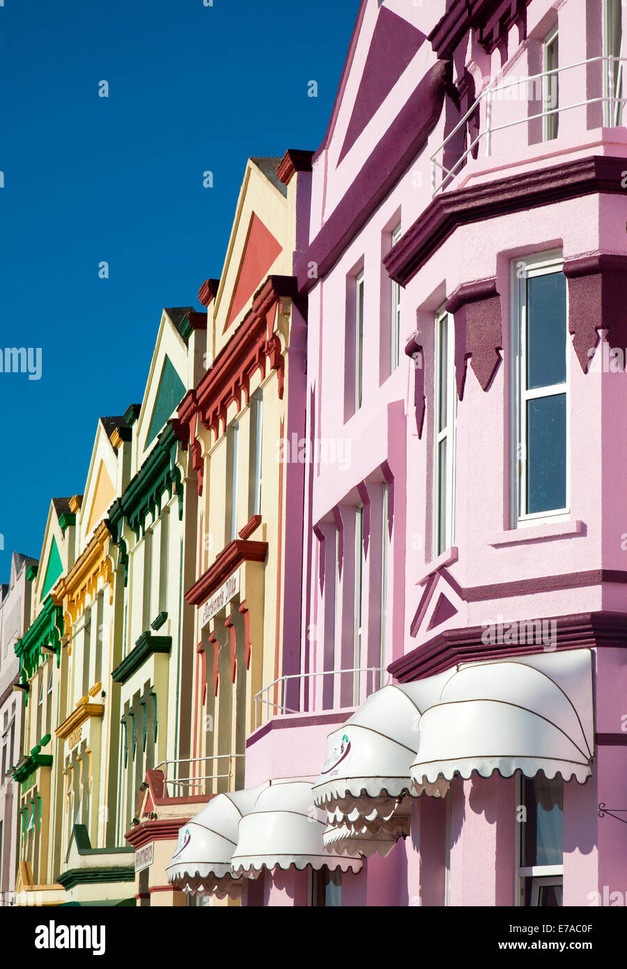 Colourfully painted guesthouses and hotels on the Esplanade, Paignton ...