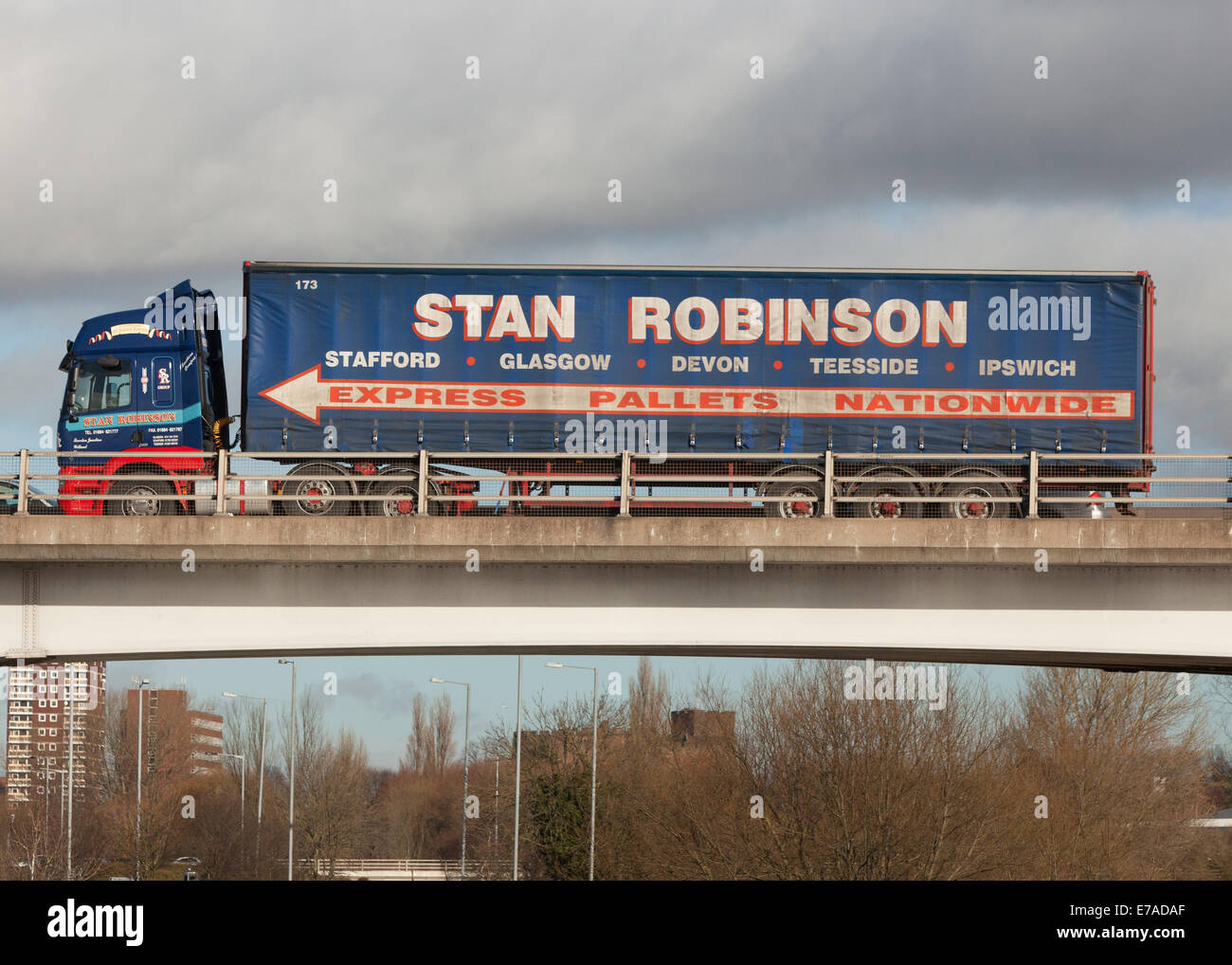 A curtain sided articulated lorry carrying palletised goods passing ...