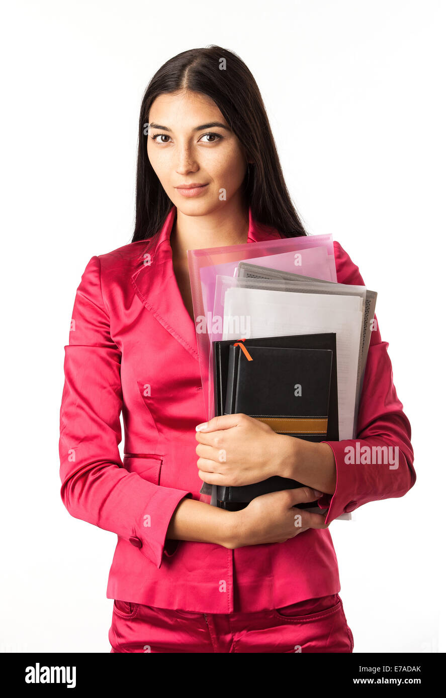 Portrait of a young beautiful girl holding files and standing against ...