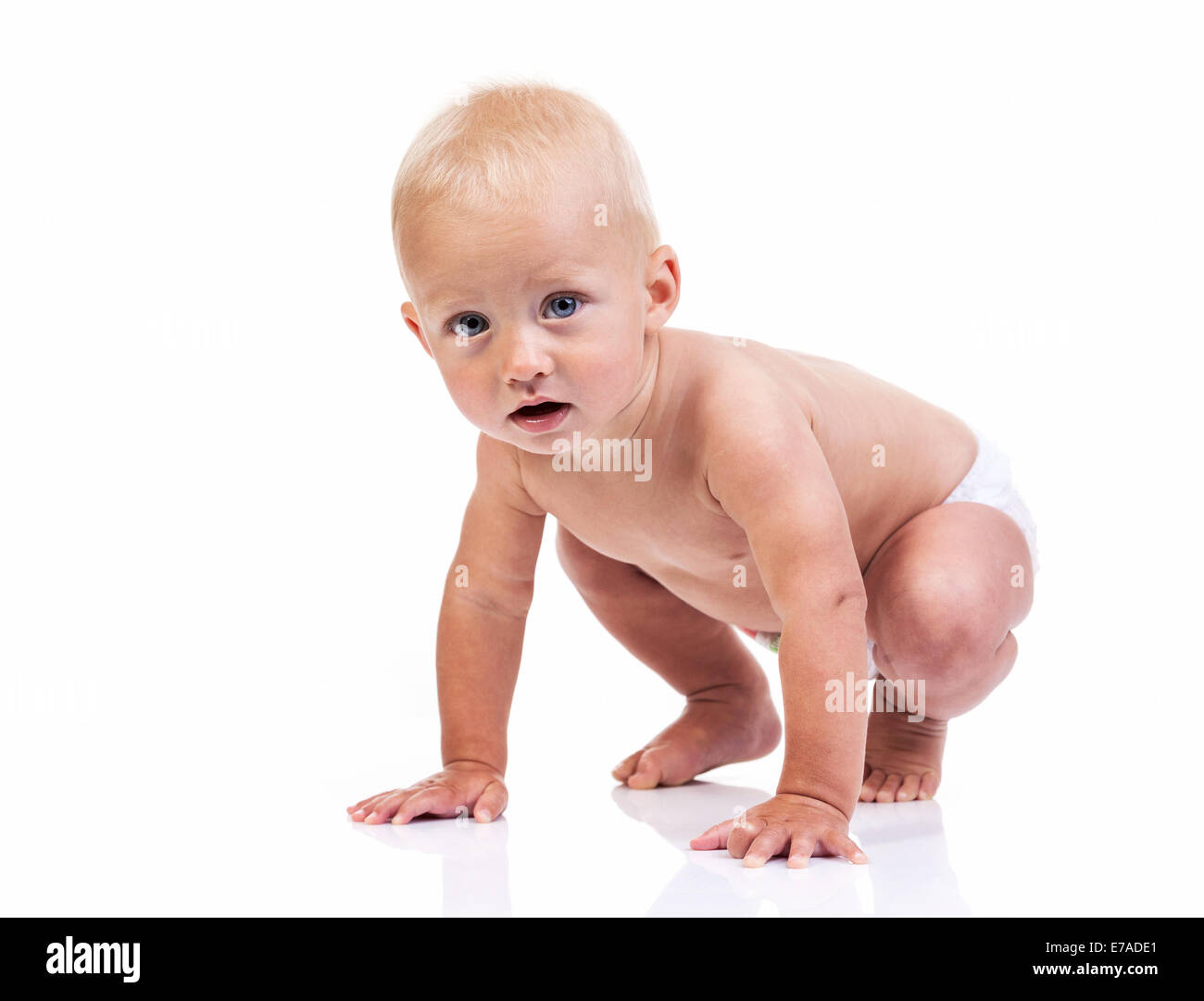 Cute baby boy crouching over white background Stock Photo - Alamy