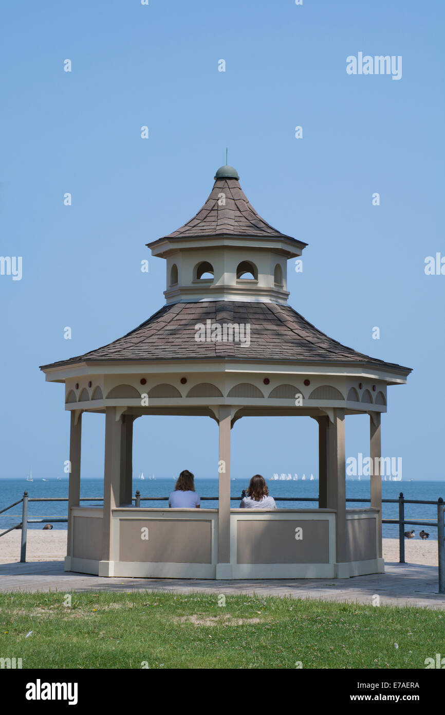New York, Rochester, Ontario Beach. Two women looking out at Lake ...