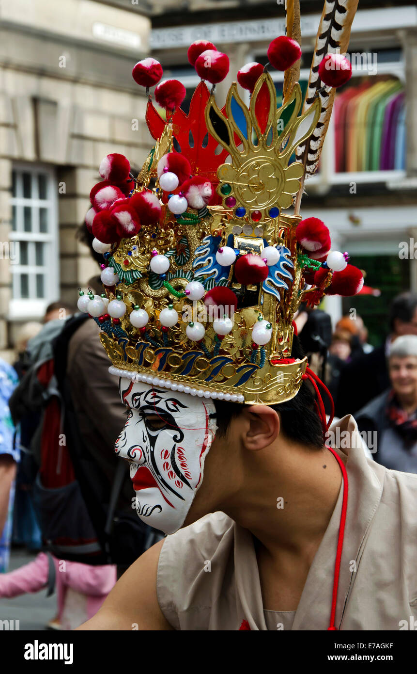 Man in very strange mask and headdress promoting a show at the annual ...