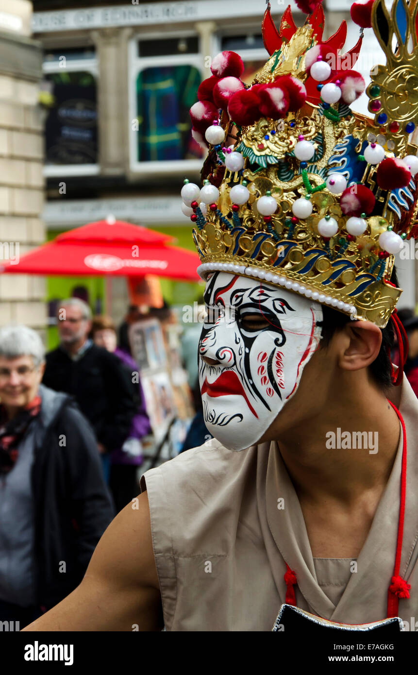 Man in very strange mask and headdress promoting a show at the annual ...