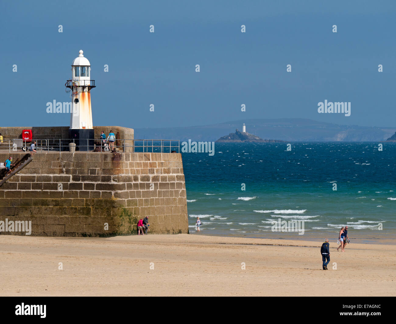St. Ives harbour beach and pier with Godrevy lighthouse in the distance ...