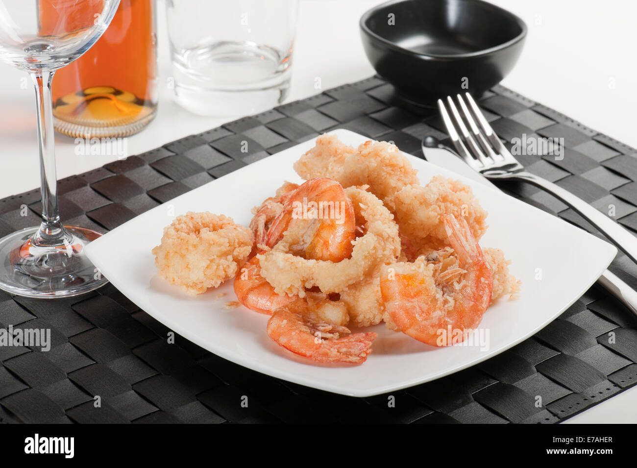 plate with fried mixed seafood with cutlery Stock Photo - Alamy