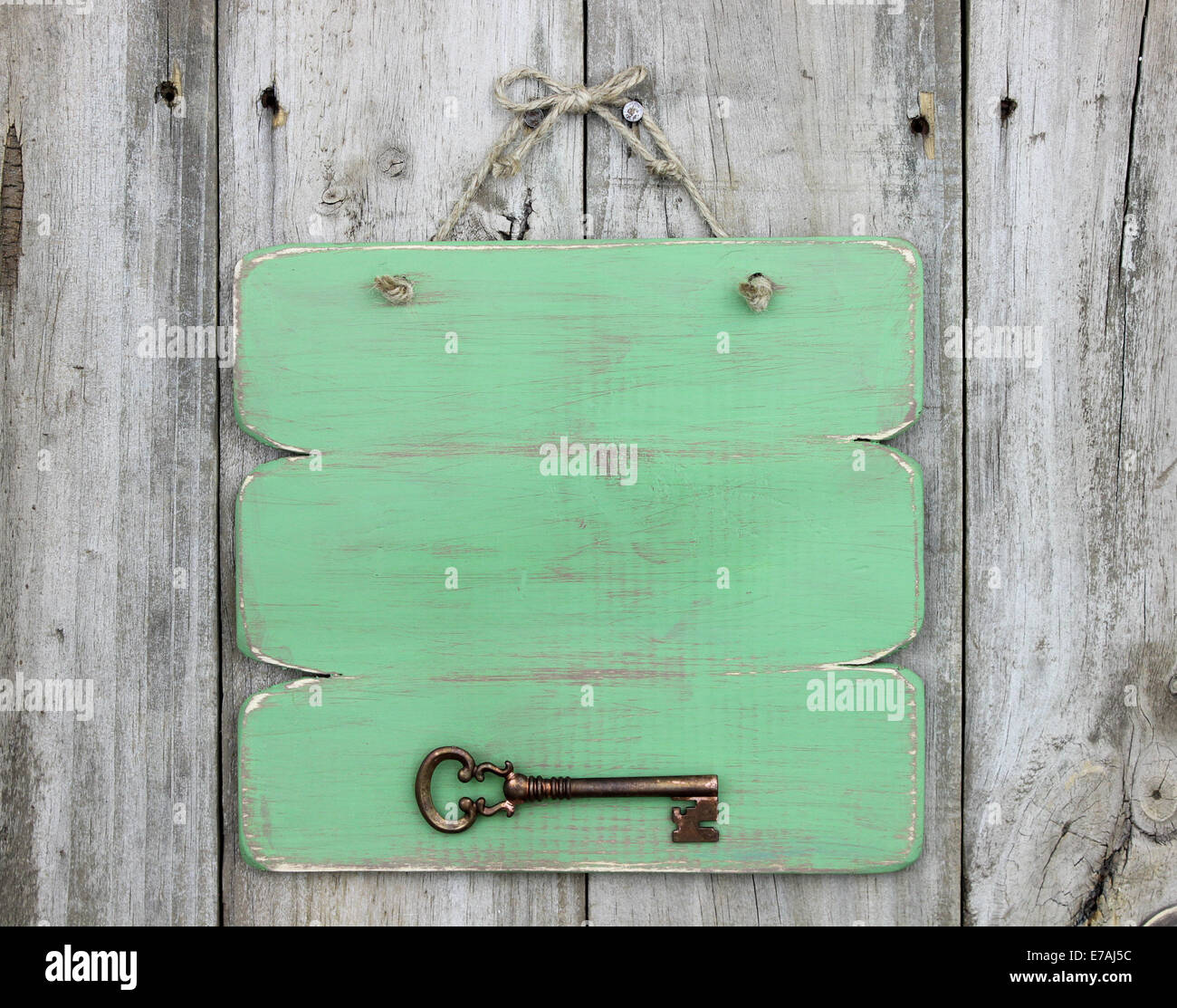 Blank green sign with bronze antique skeleton key hanging on weathered ...