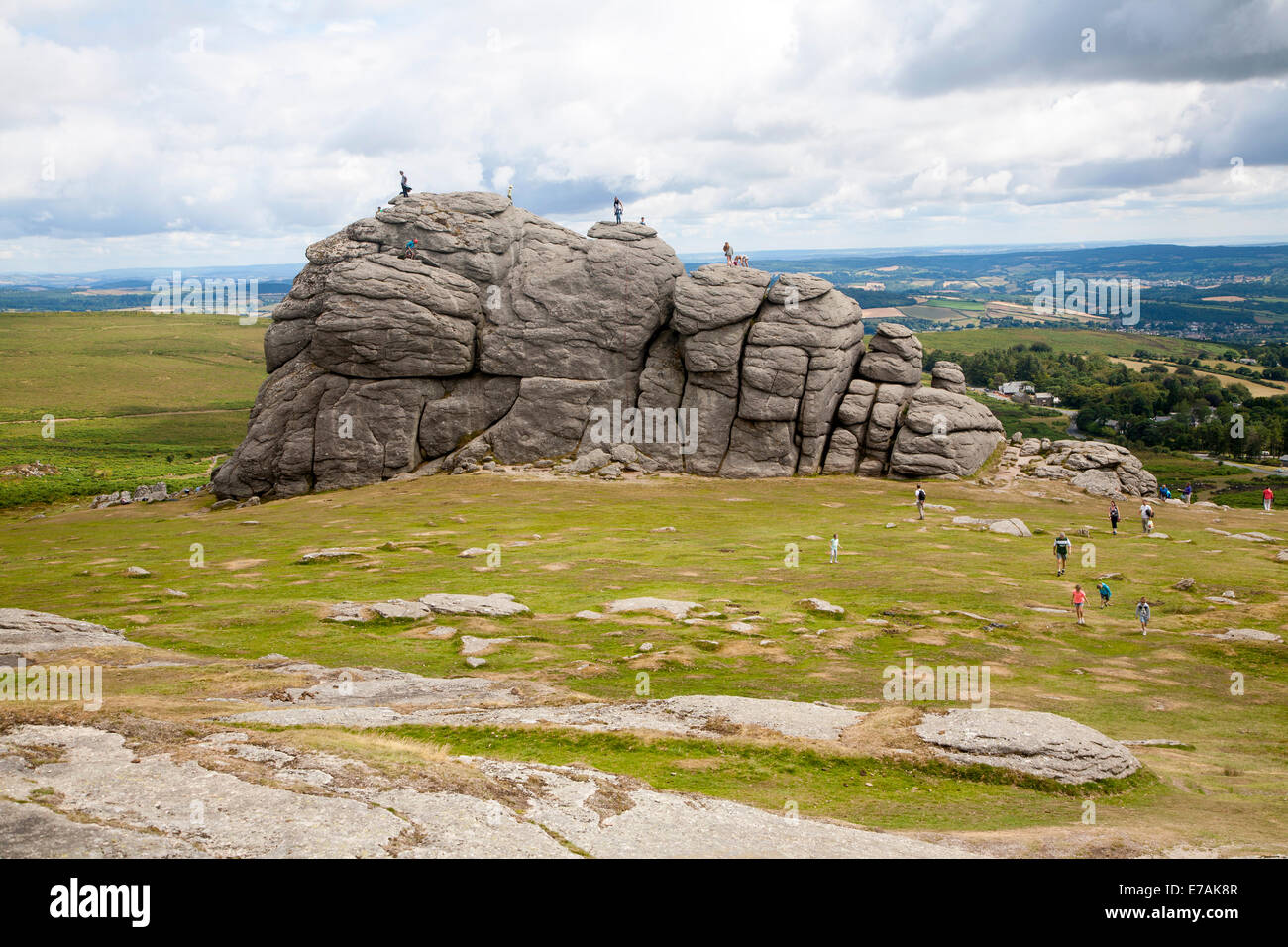 People scrambling on the granite tor of Haytor, Dartmoor national park ...