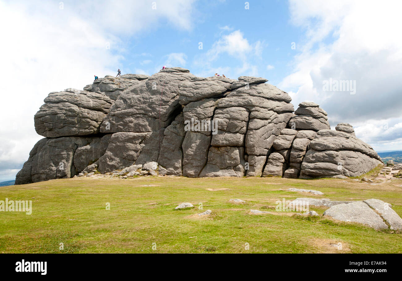 People scrambling on the granite tor of Haytor, Dartmoor national park ...