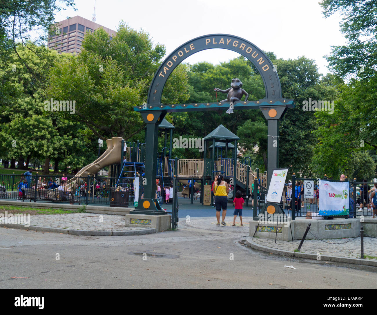 woman and child walking into Tadpole Playground public gardens Boston ...