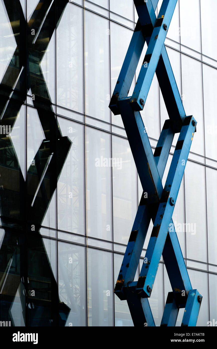 Reflection of a cherry picker in glass window Stock Photo - Alamy