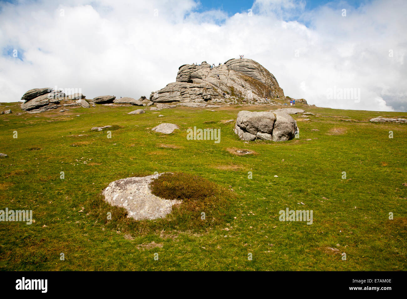 People scrambling on the granite tor of Haytor, Dartmoor national park ...