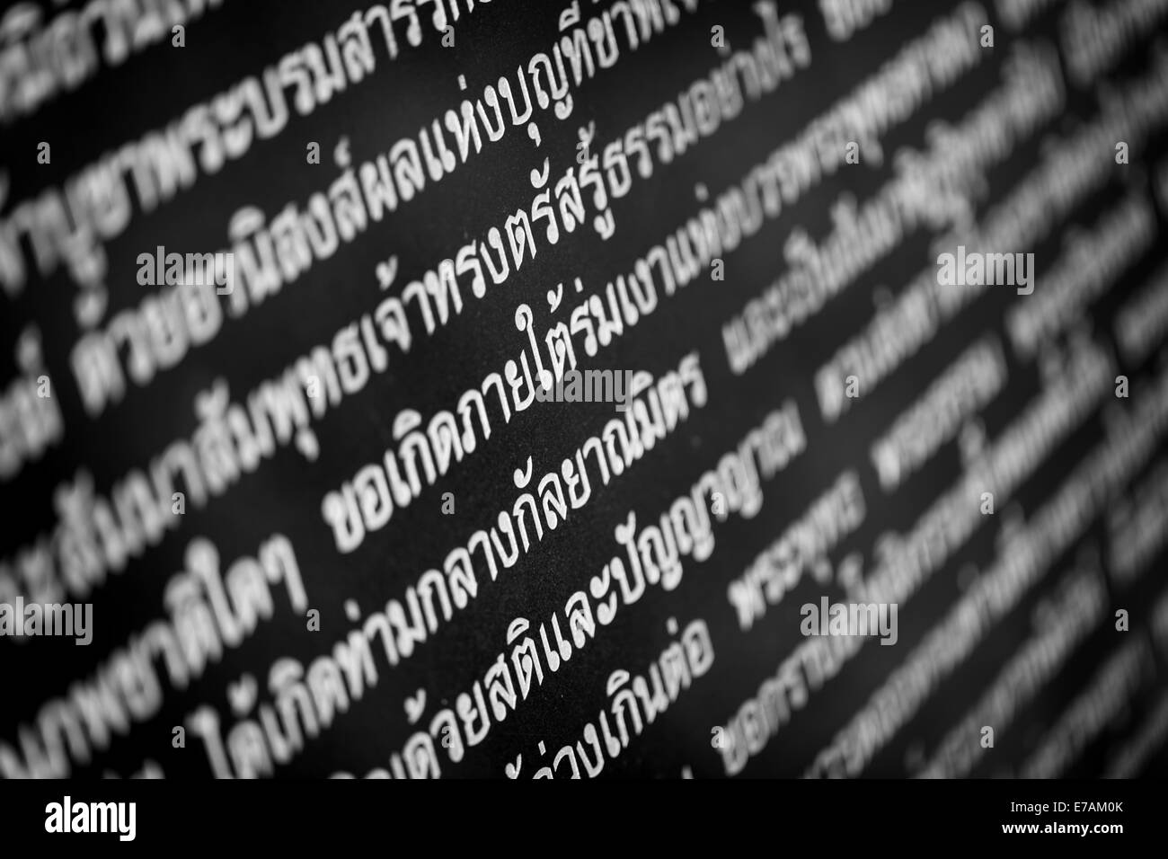 Religious text on the stone wall in a Buddhist temple. Thailand, Phuket ...
