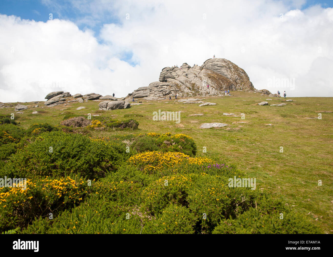 People scrambling on the granite tor of Haytor, Dartmoor national park ...