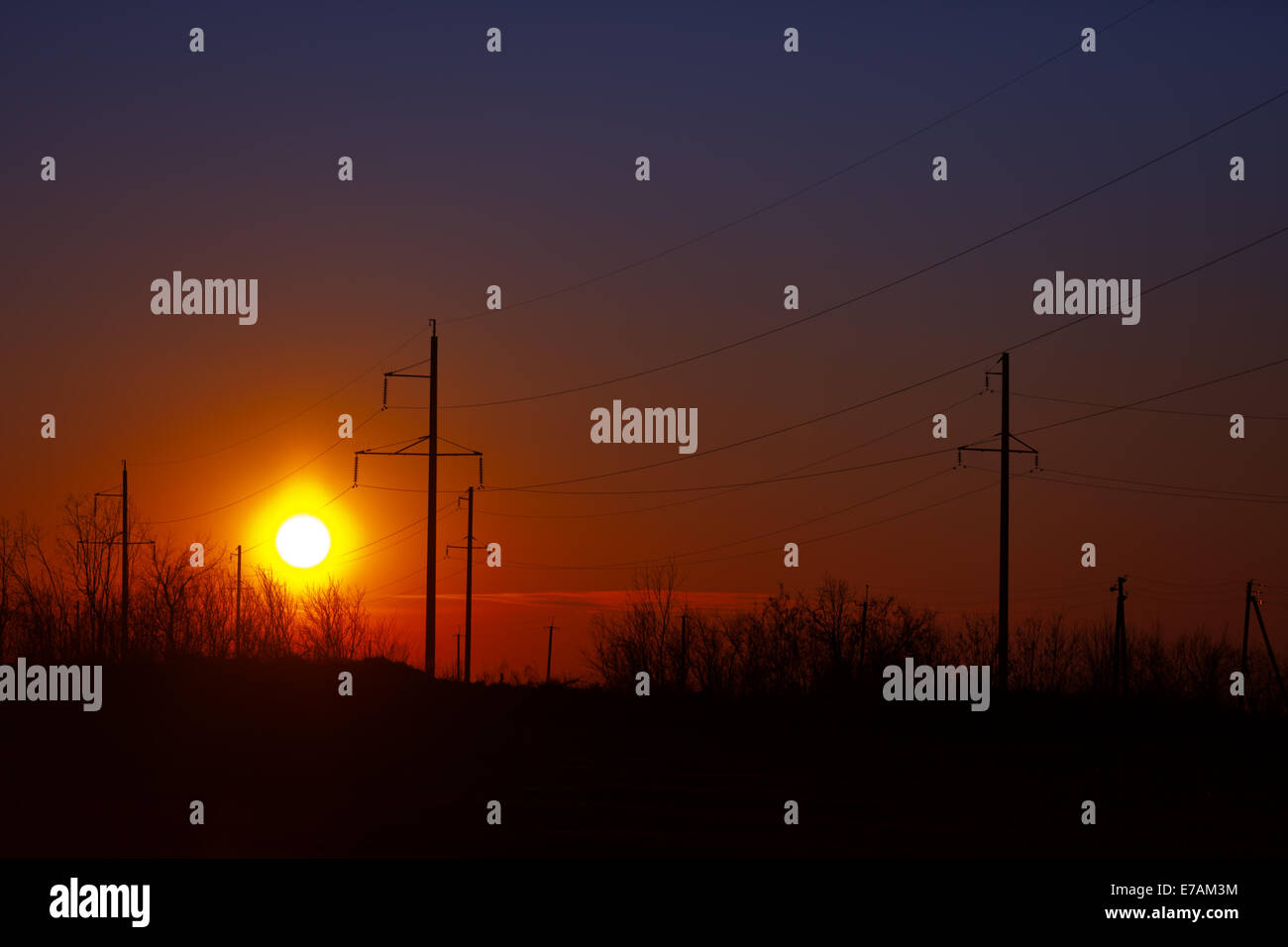 Poles of power lines at sunset - industrial beautiful landscape Stock ...