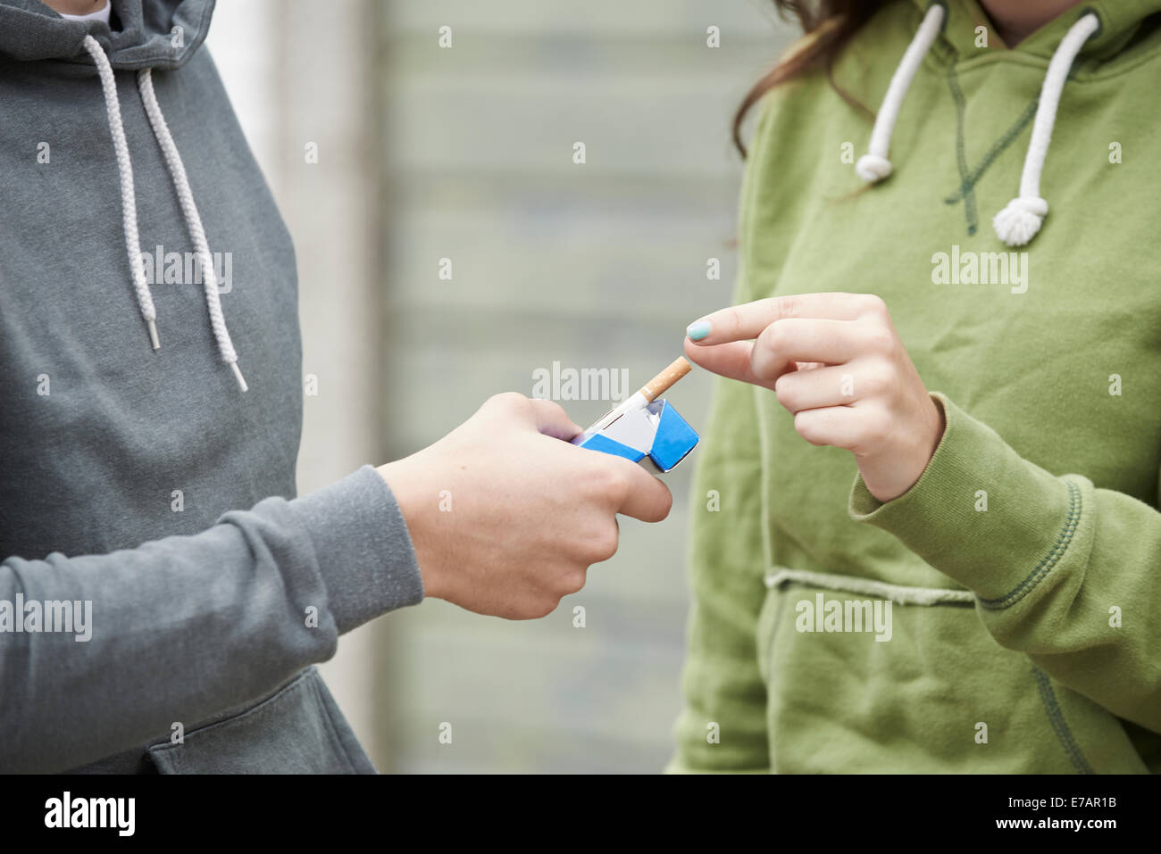 Close Up Of Teenager Boy Offering Girl Cigarette Stock Photo - Alamy