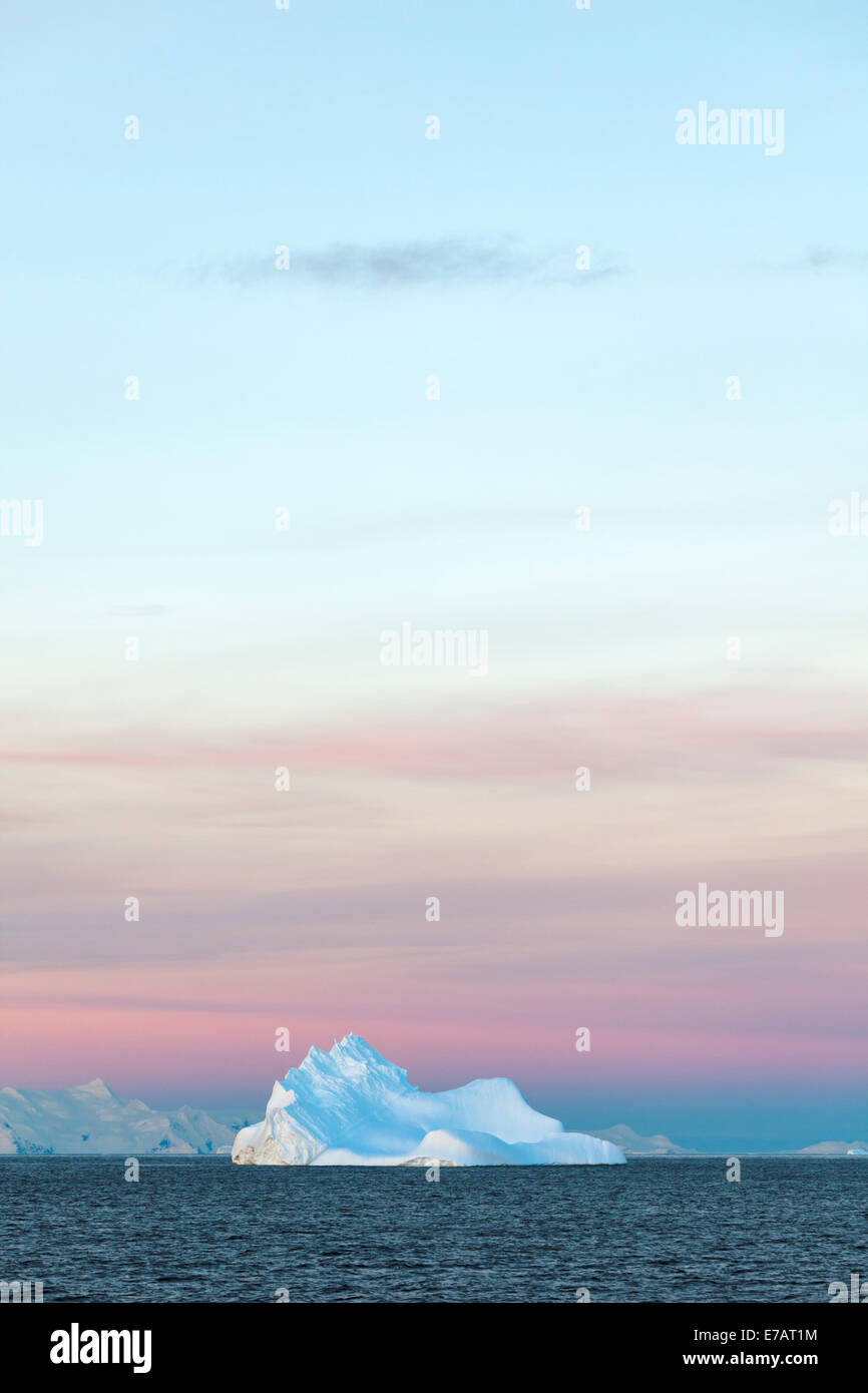 Iceberg against a pastel colored sky during dawn at Marguerite Bay ...