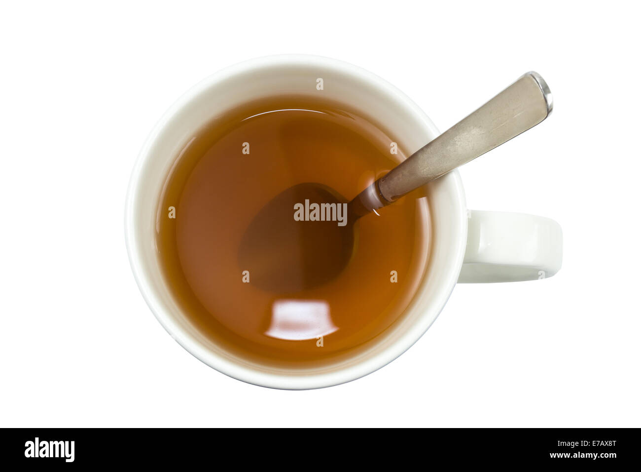 Closeup of a cup of tea with spoon viewed from above, isolated on white ...