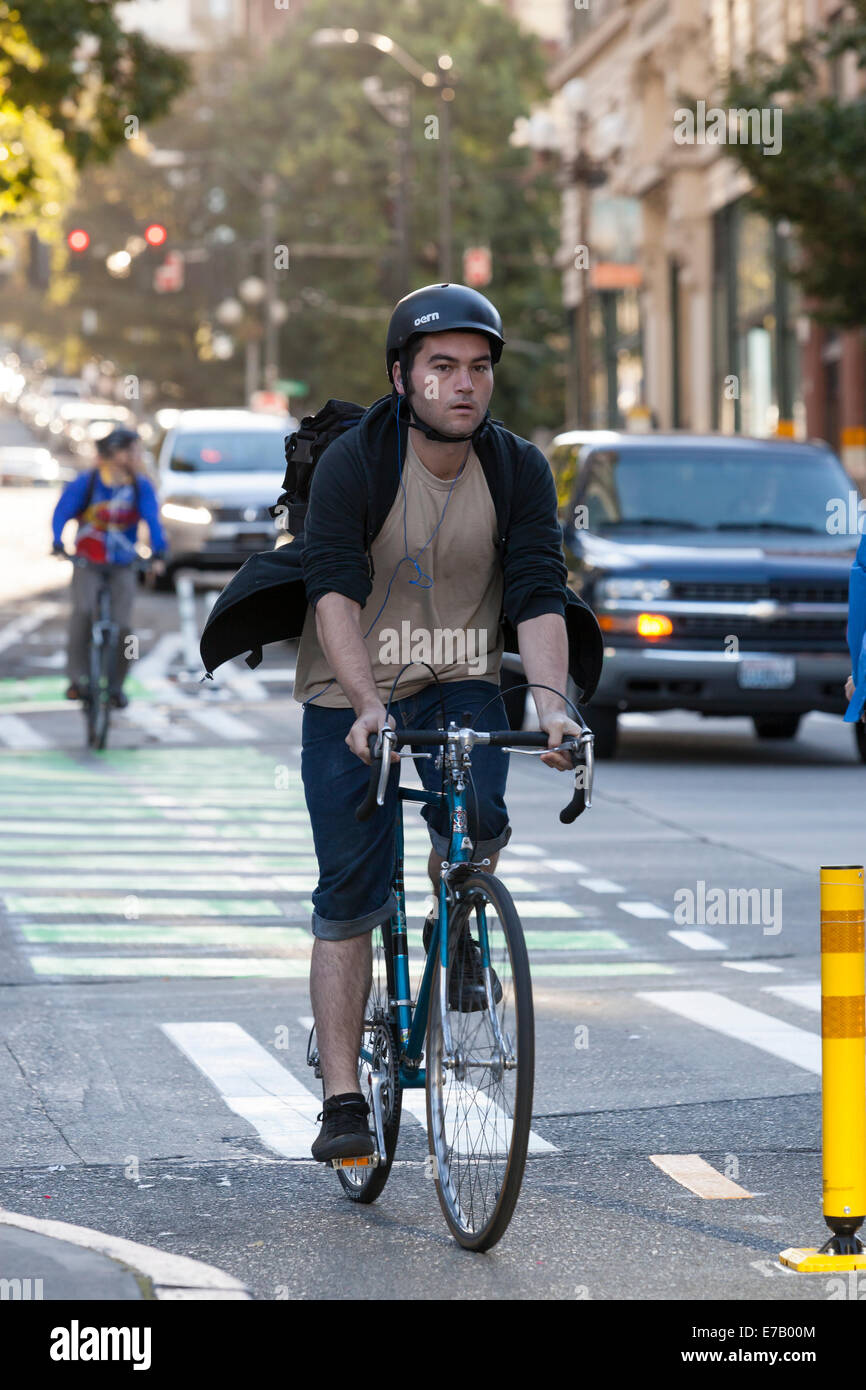 Seattle, Washington, USA. 11th Sep, 2014. Man cycling on Yesler Way ...