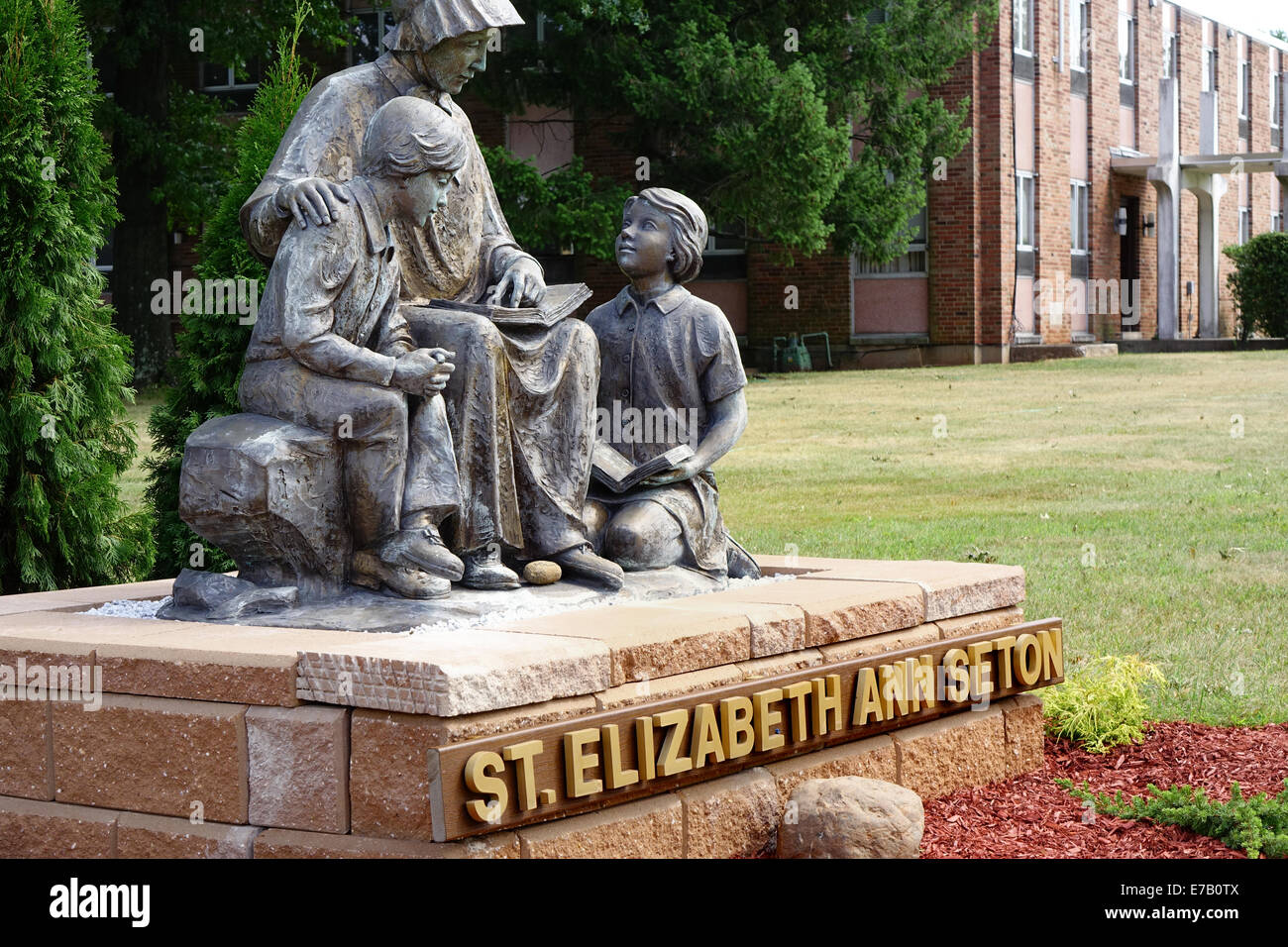 Bronze statue of Saint Elizabeth Ann Seton and two children next to the ...