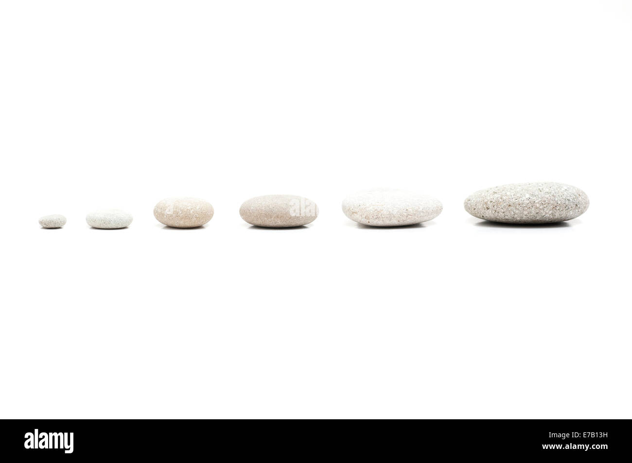 Pebbles in a line from small to large one Stock Photo - Alamy