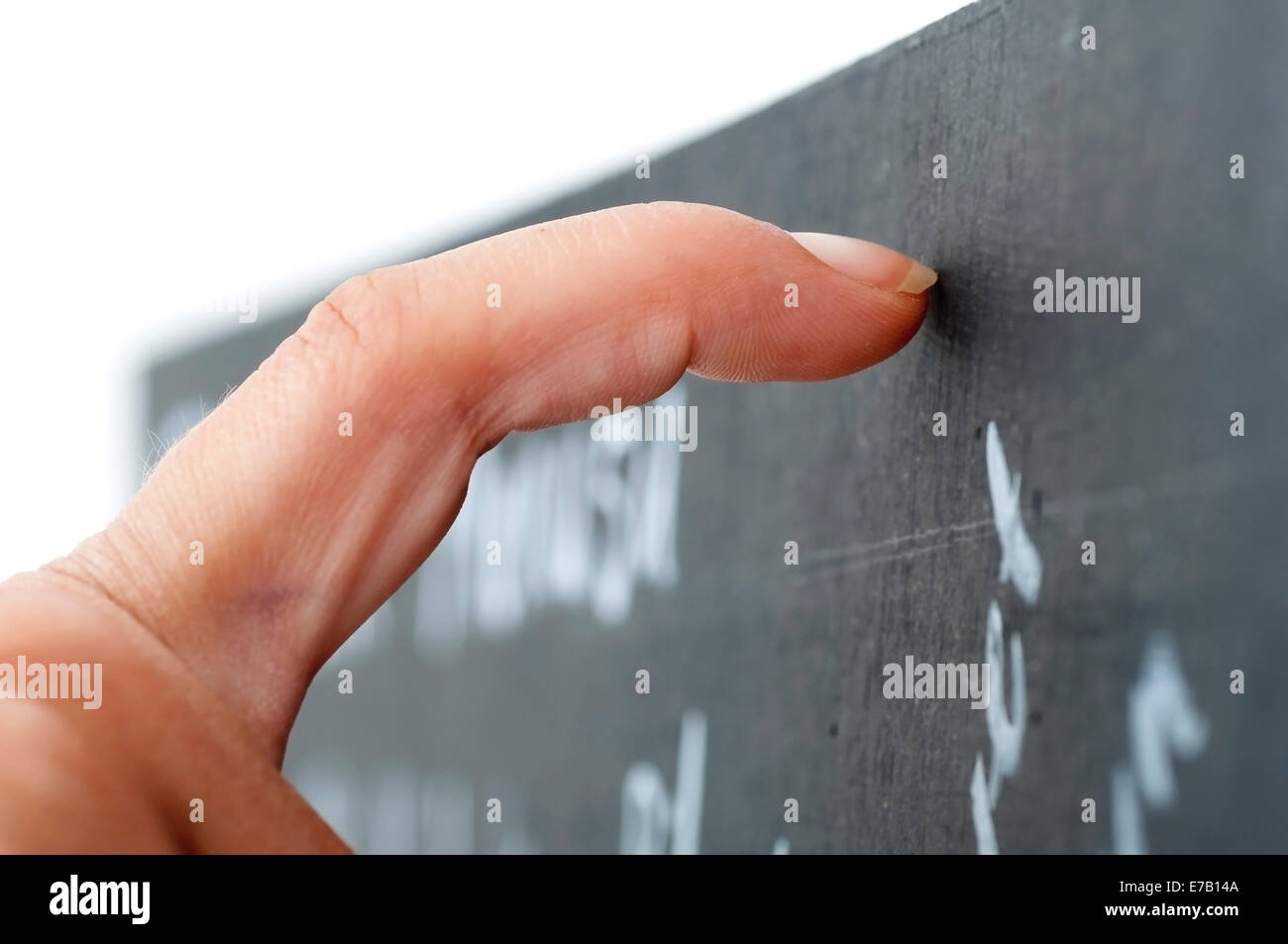 Long nail on chalkboard Stock Photo - Alamy