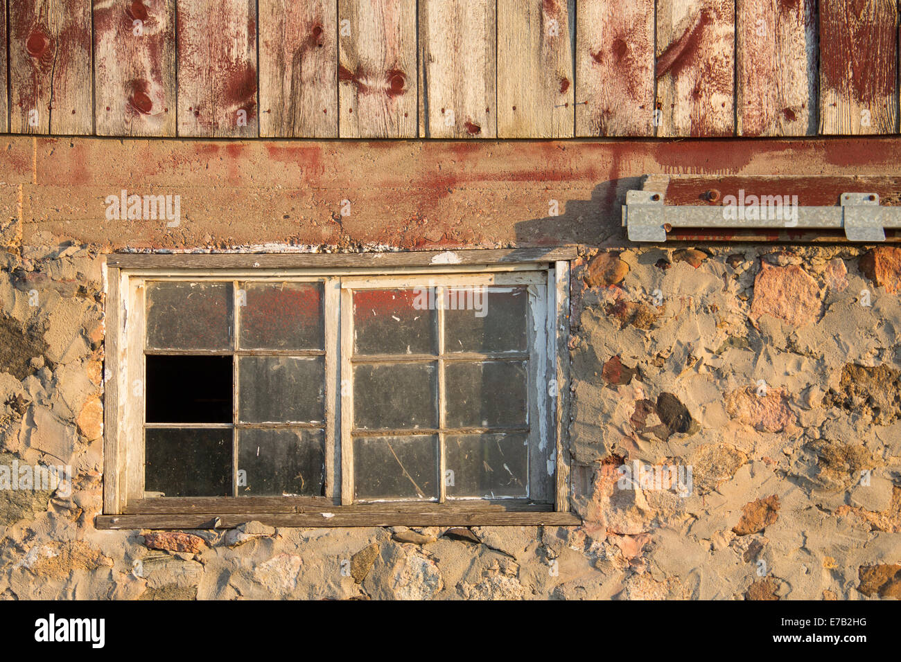 Broken window in a weathered and abandoned barn. Warm light Stock Photo ...