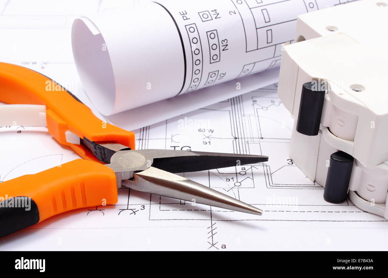 Rolled electrical diagrams, electric fuse and work tools lying on ...