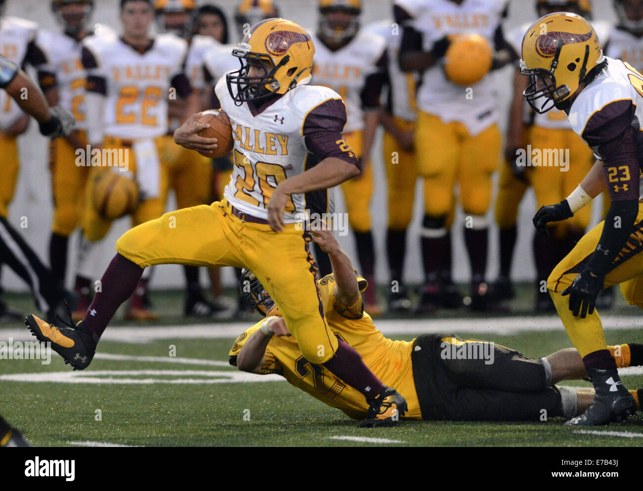 Usa. 11th Sep, 2014. SPORTS -- Valley's C.J. Torres breaks the tackle ...