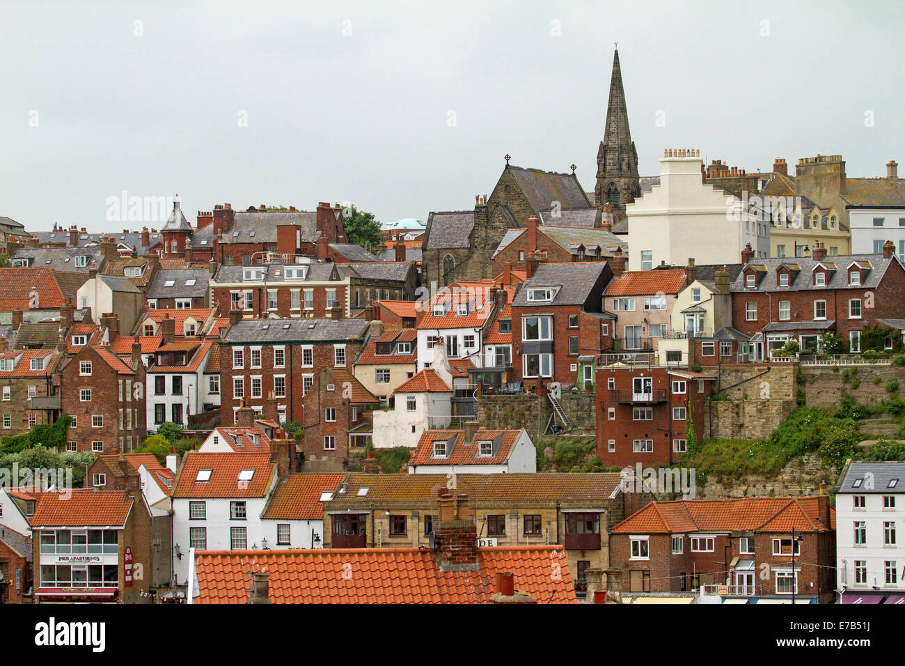 Crowded red brick houses and apartment blocks on steep hillside at ...