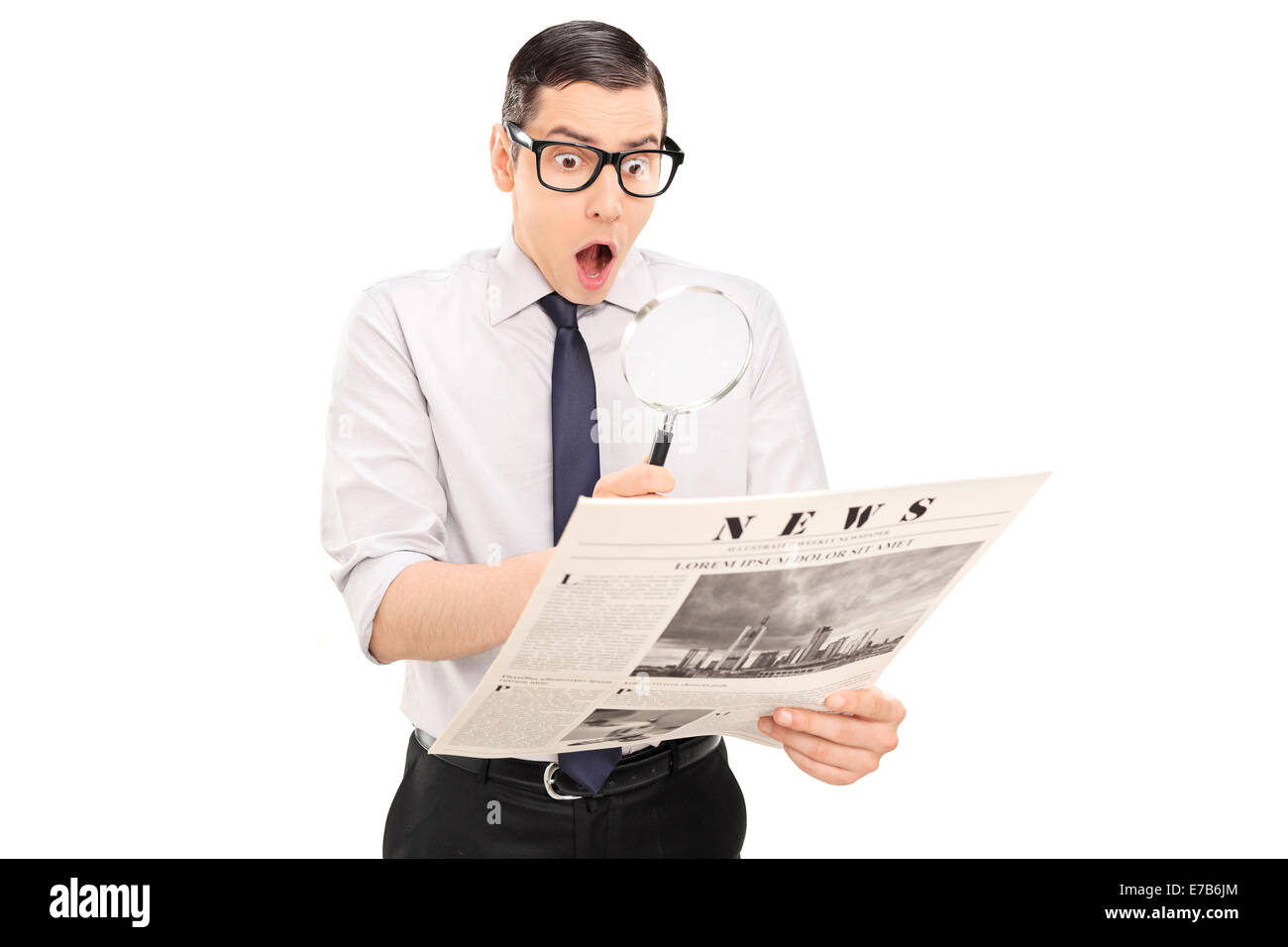 Shocked man reading the news through a magnifier isolated on white ...