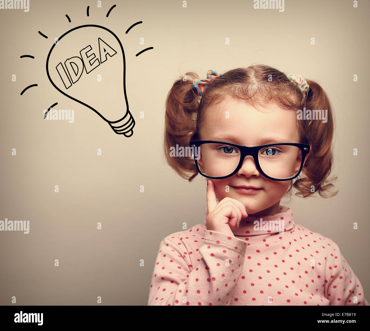 Cute thinking kid girl in glasses with idea bulb looking Stock Photo ...