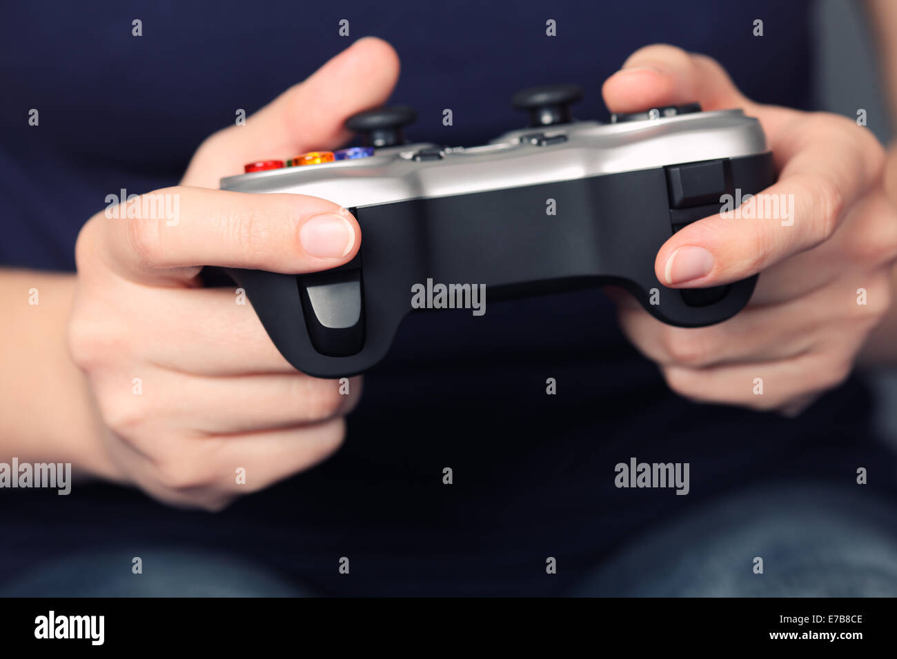 Young woman plays video game using a gamepad. Cross-processing Stock ...