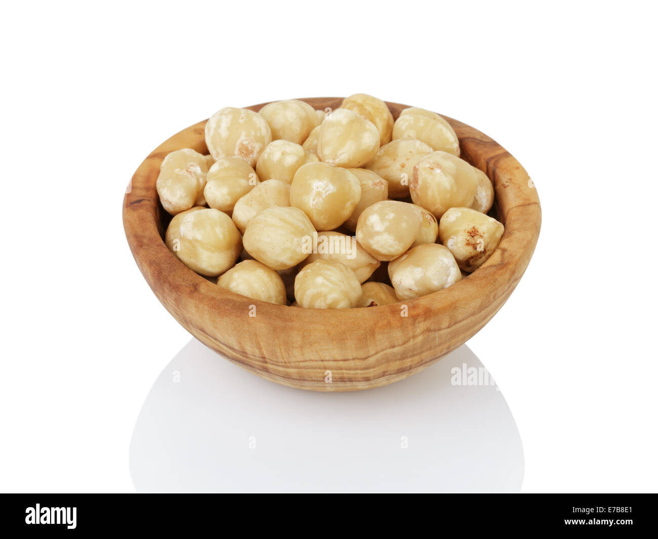 peeled and cleaned hazelnut kernels in wood bowl, isolated on white ...