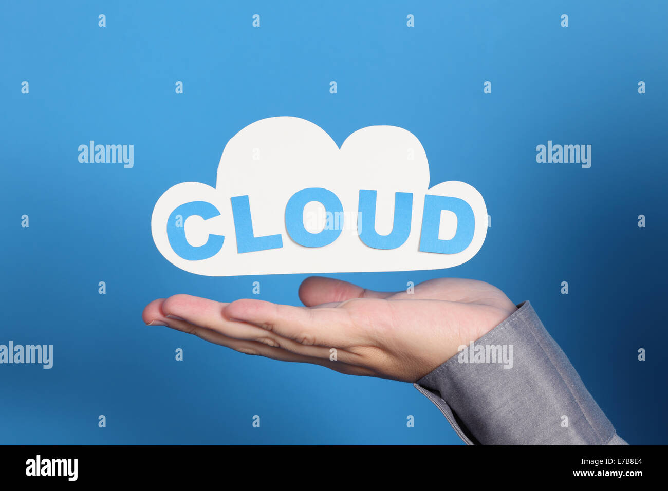 Woman's hand holding a paper cloud with word "Cloud". Cloud computing ...