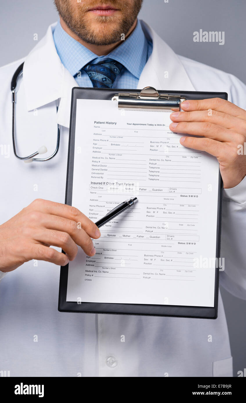 Doctor holding folder with form Stock Photo - Alamy
