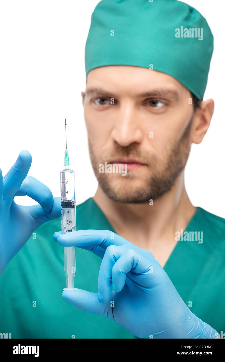 Confident male doctor with syringe Stock Photo - Alamy