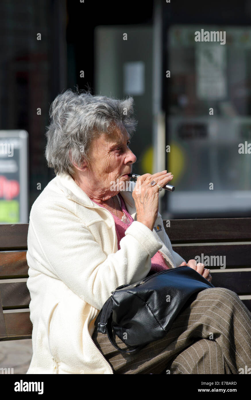 Elderly lady smoking an electronic cigarette Stock Photo - Alamy