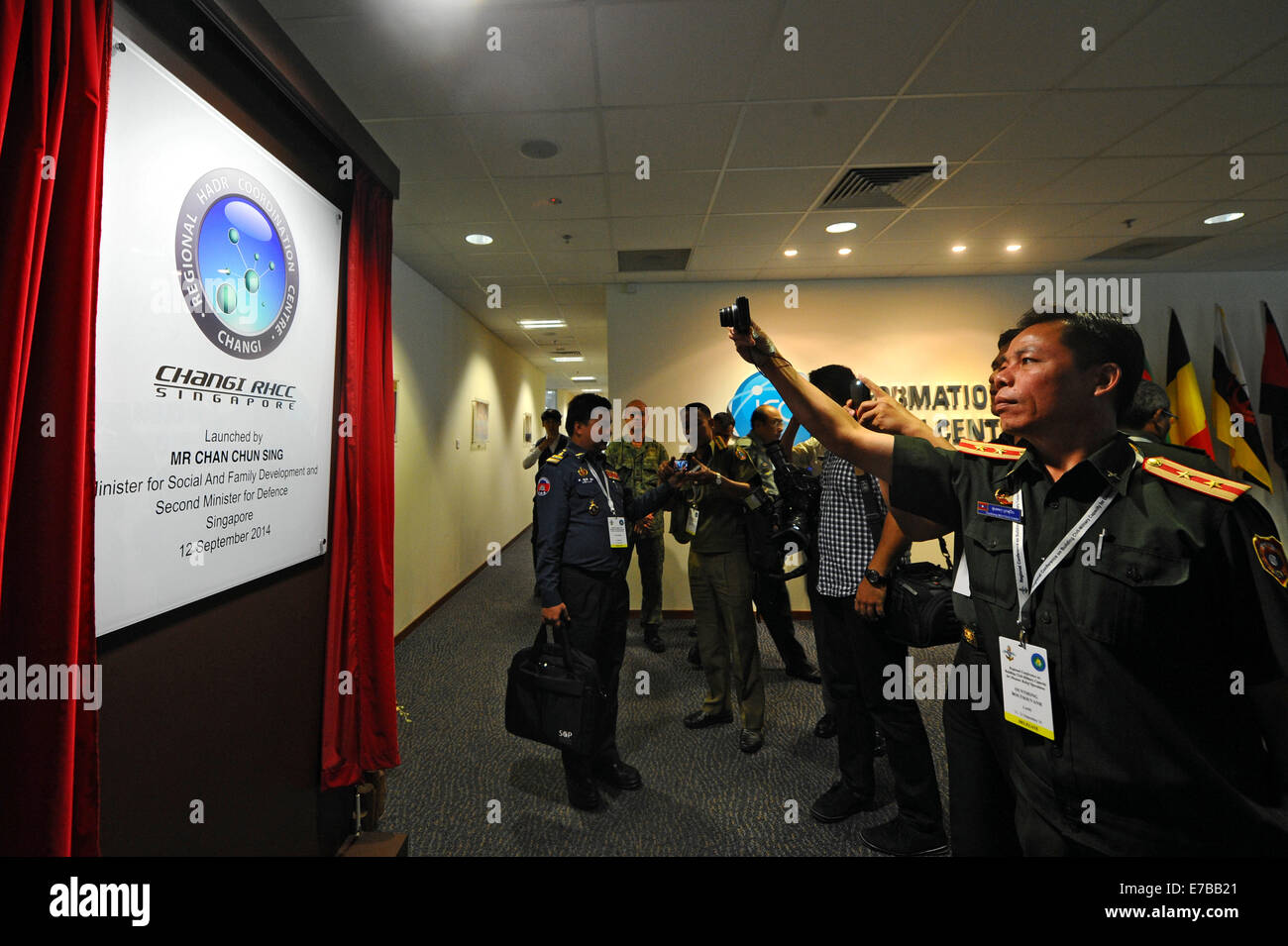 Singapore. 12th September, 2014. A Laos' military personnel (R) attends ...