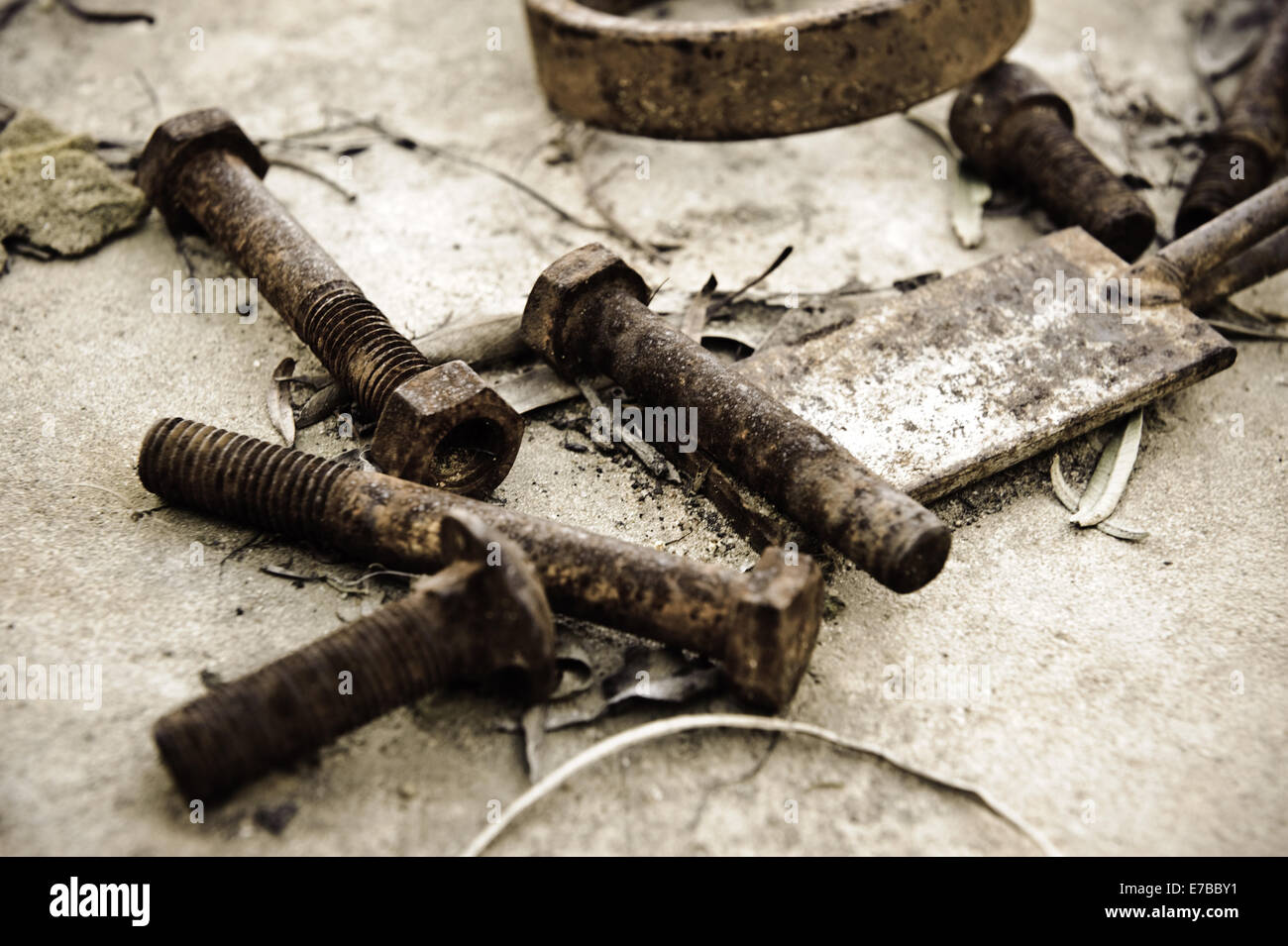 Collection of rusted bolts, nuts and metal on a farmyard scrapheap ...