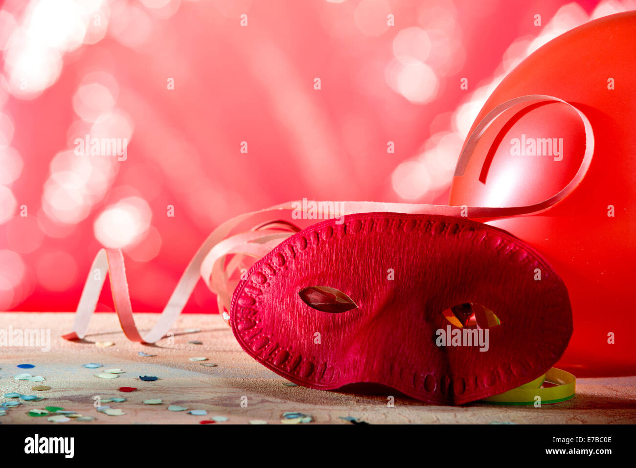 red carnival mask with colored carnival glitter Stock Photo - Alamy