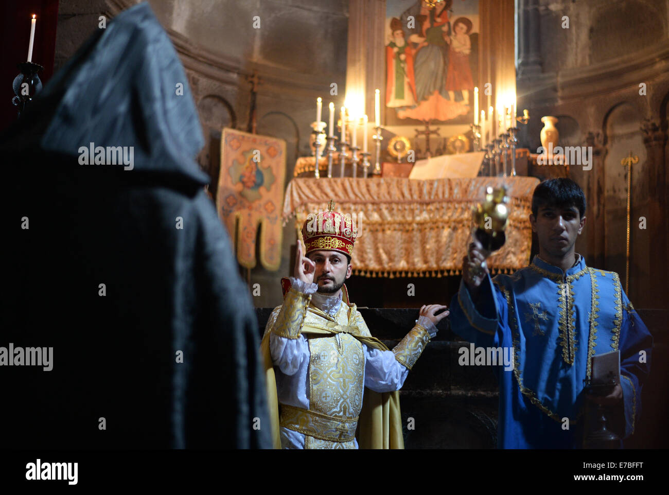 A monk, the pastor and a sexton wear religious habit during a church ...