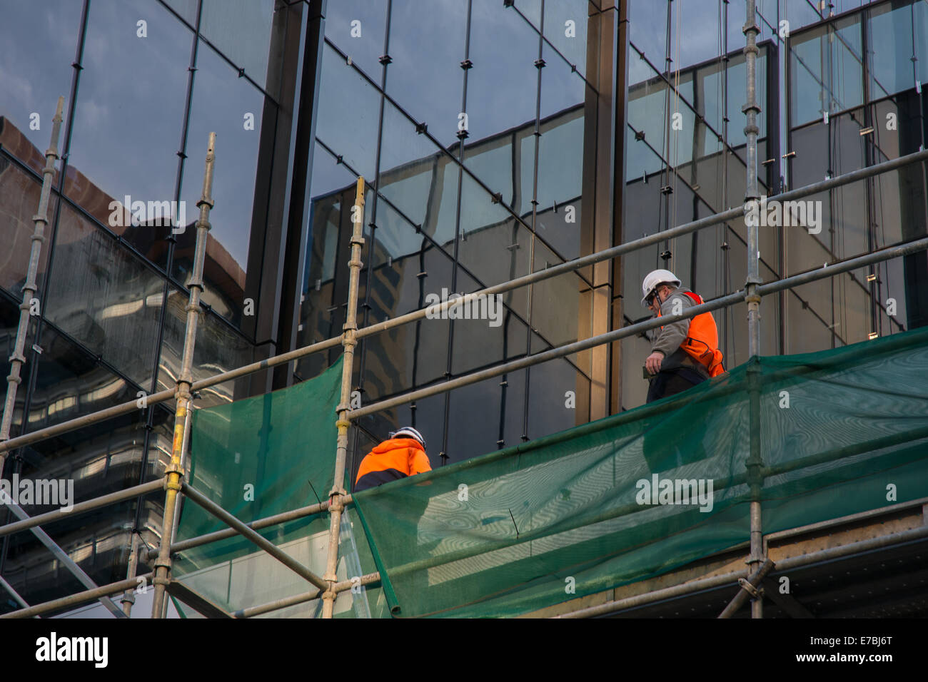 Builders on scaffolding Stock Photo - Alamy