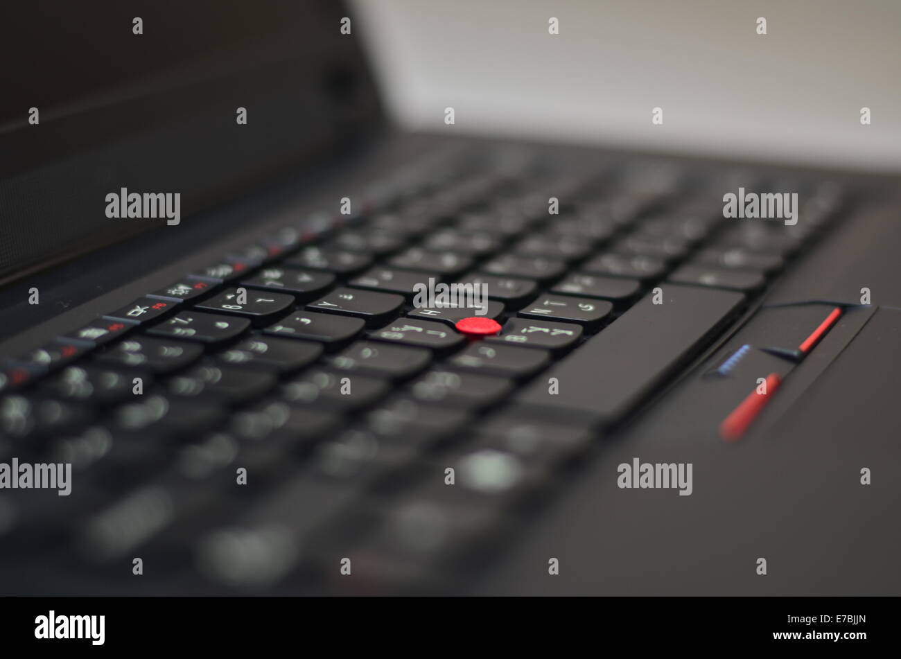 Black laptop keyboard with red track ball Stock Photo - Alamy