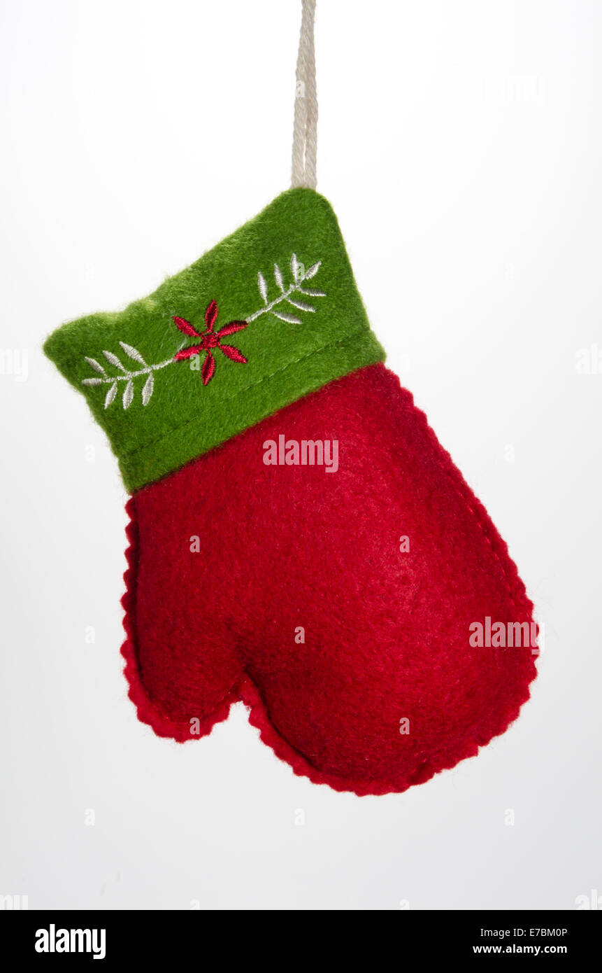 A red and green felt Christmas ornament in the shape of a mitten Stock ...