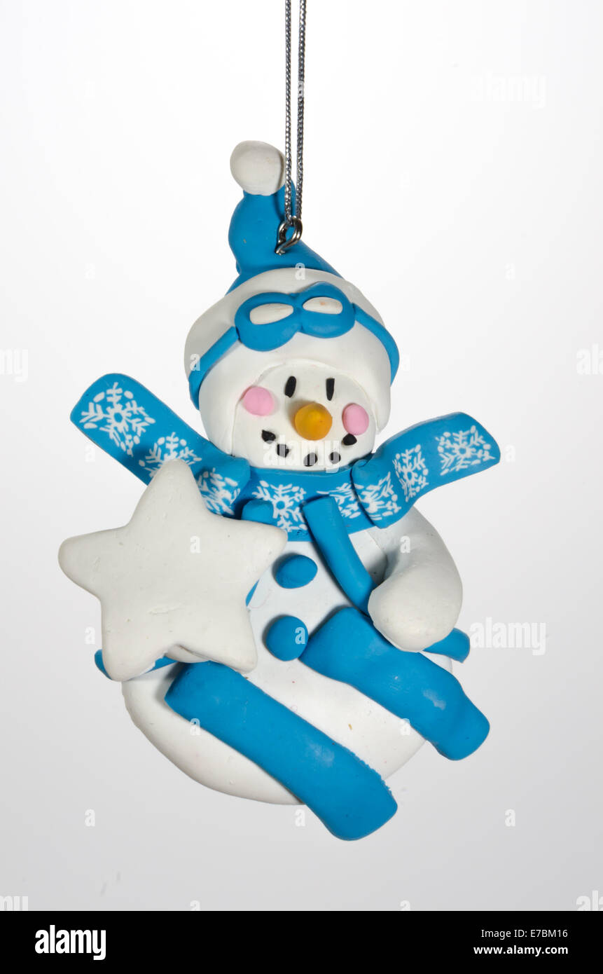 A white clay snowman with blue scarf and hat isolated on white Stock ...