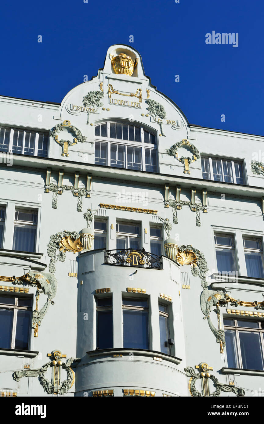A white building with golden motif on the exterior in the City of ...