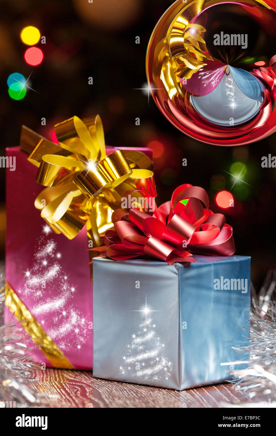 Two Christmas gift boxes with reflective glass tree ball decoration ...